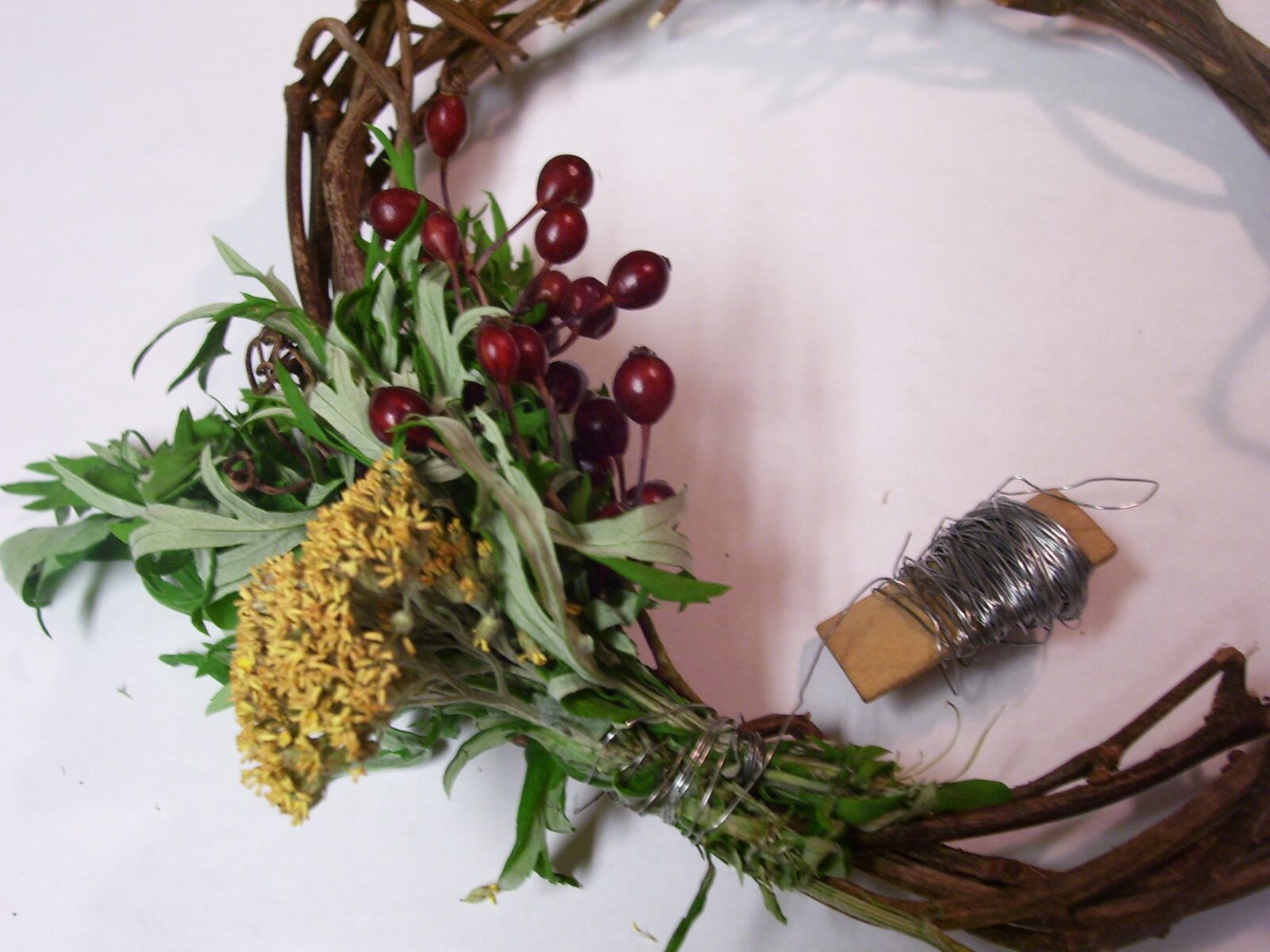first 2 bunches of herbs on grapevine wreath base - Iris WeaverIris Weaver